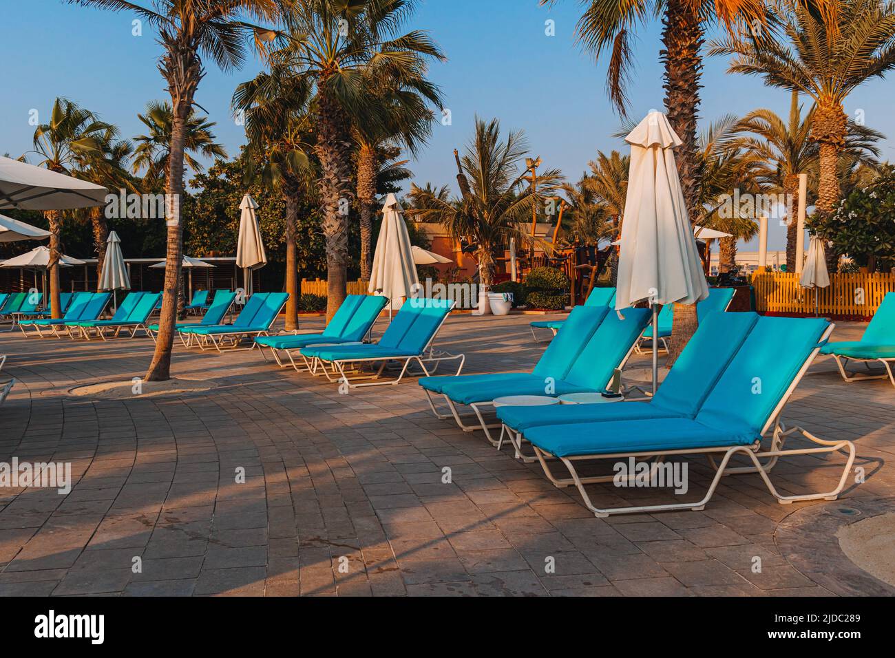 Blue bed pool with a towel stand under umbrellas against the backdrop ...
