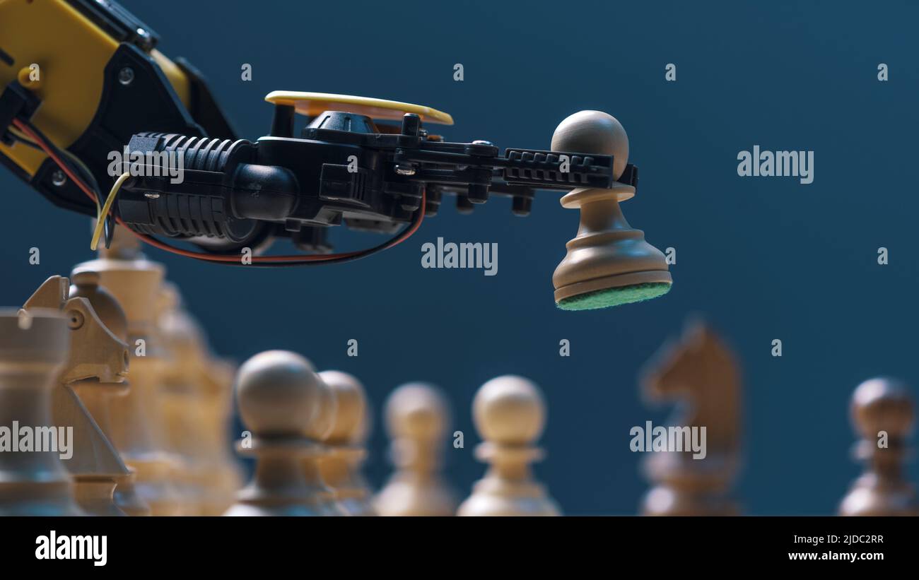 Robot moving chess pieces on chessboard, close up Stock Photo - Alamy