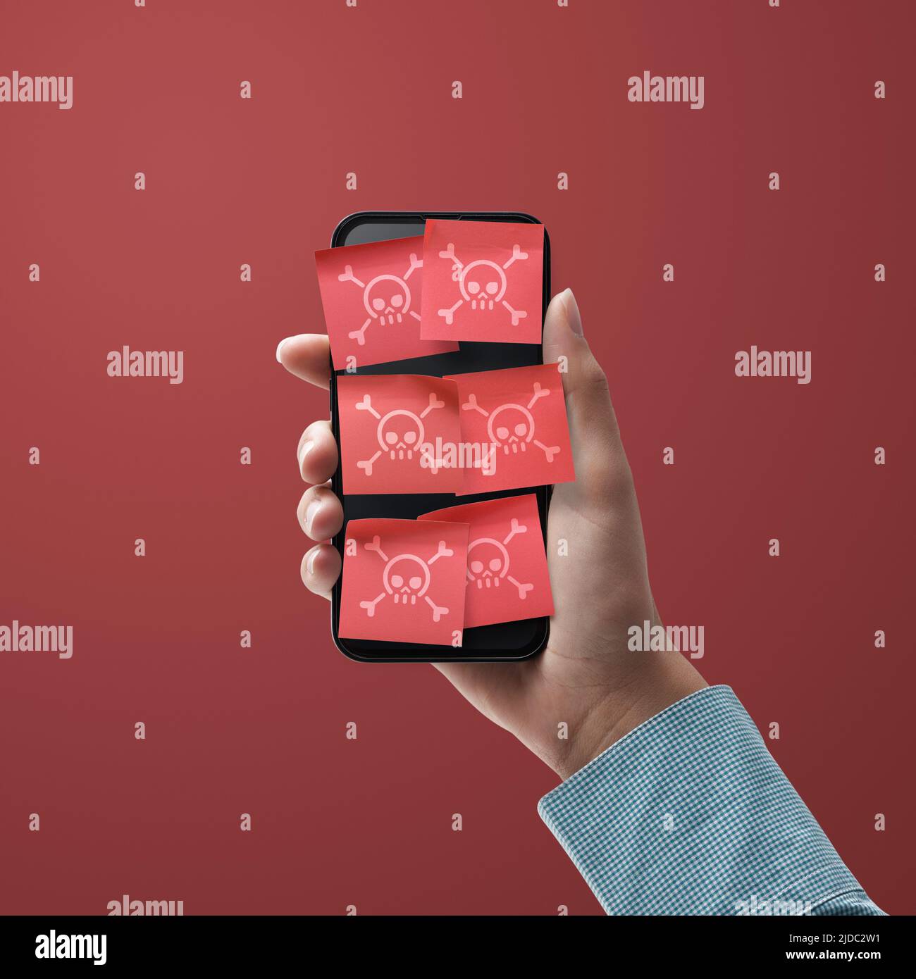 Hand holding a smartphone infected with viruses and malware ...