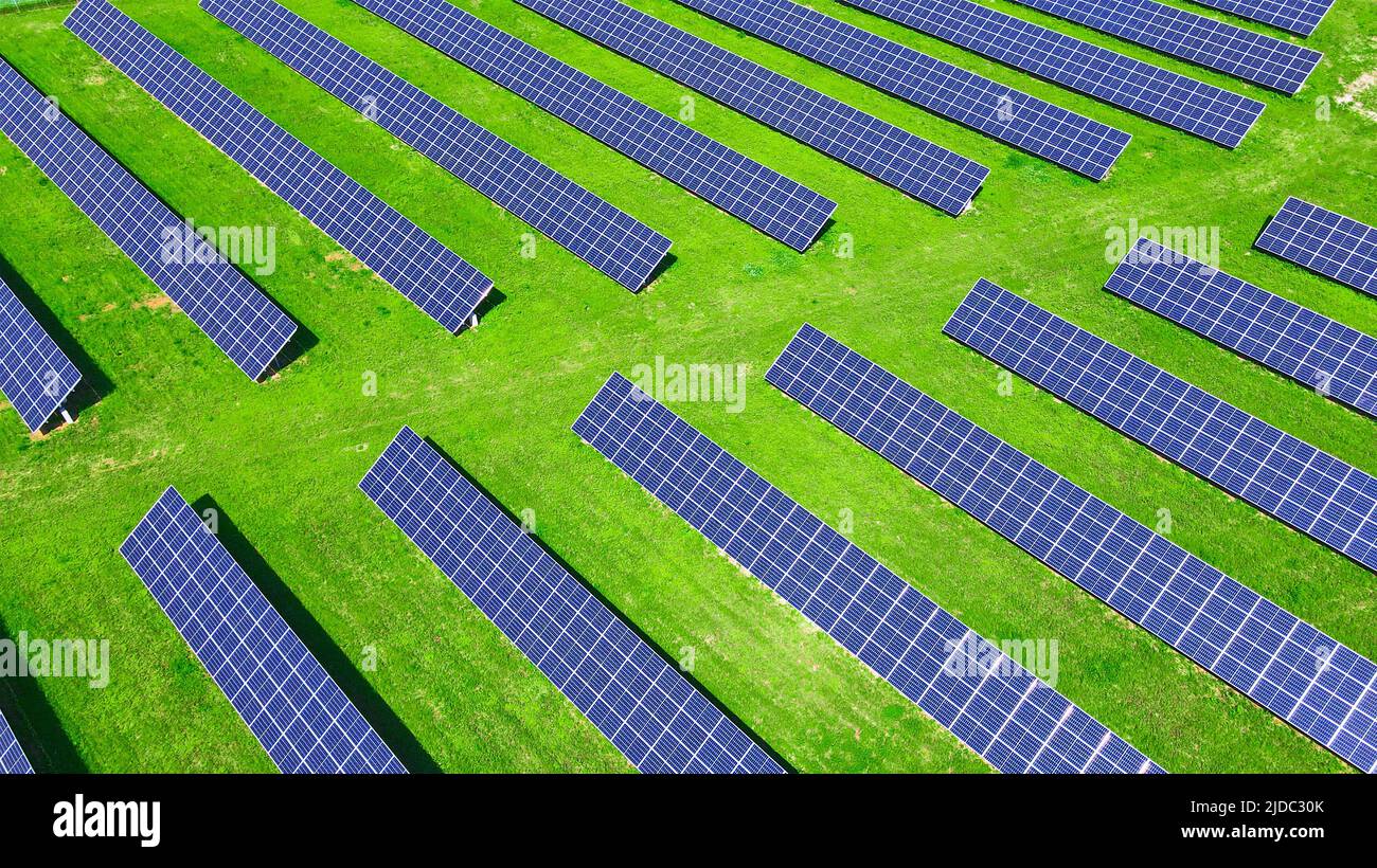 Solar panels battery in green field, aerial view. Photovoltaic modules ...