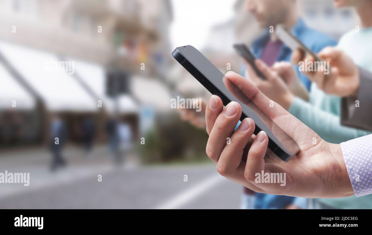 Using smartphones on street hi-res stock photography and images - Alamy