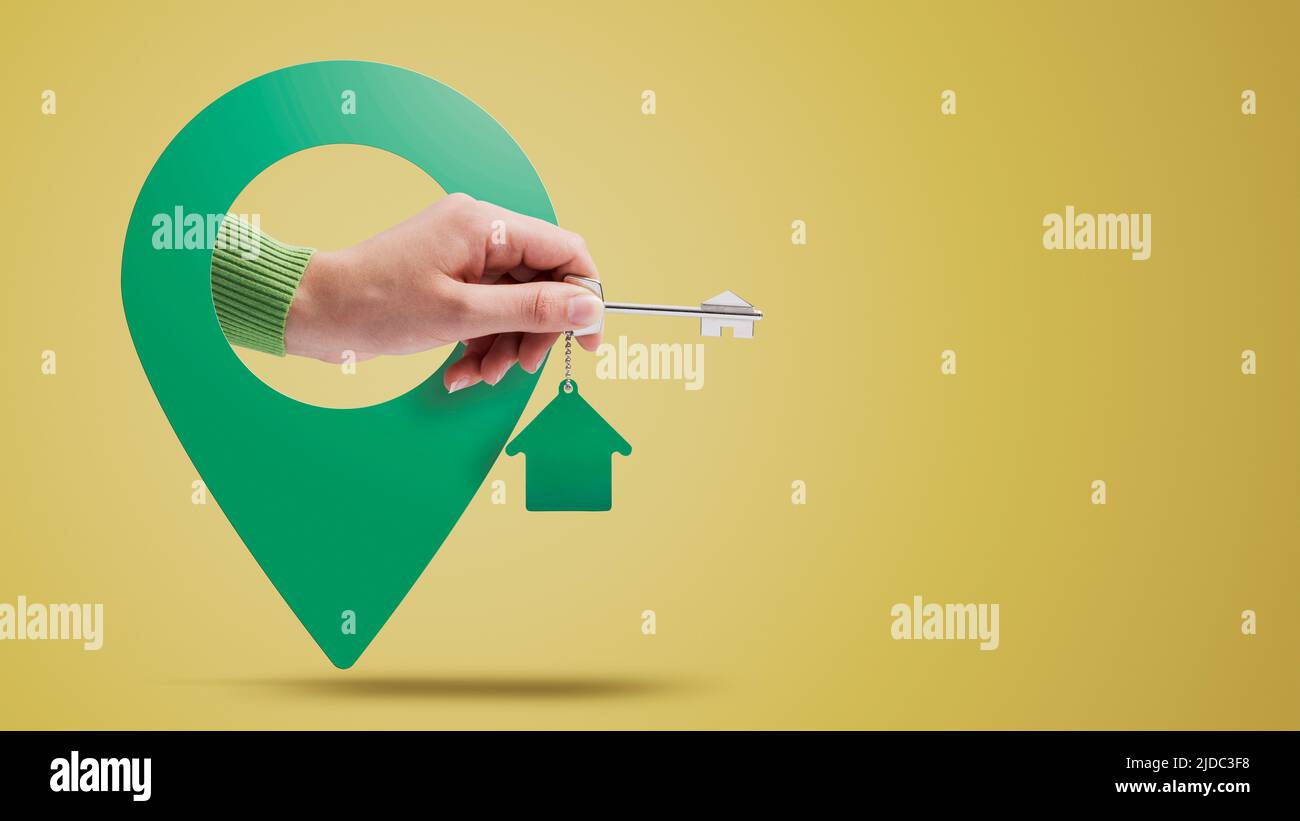 Hand holding house keys and location pin, real estate concept Stock ...