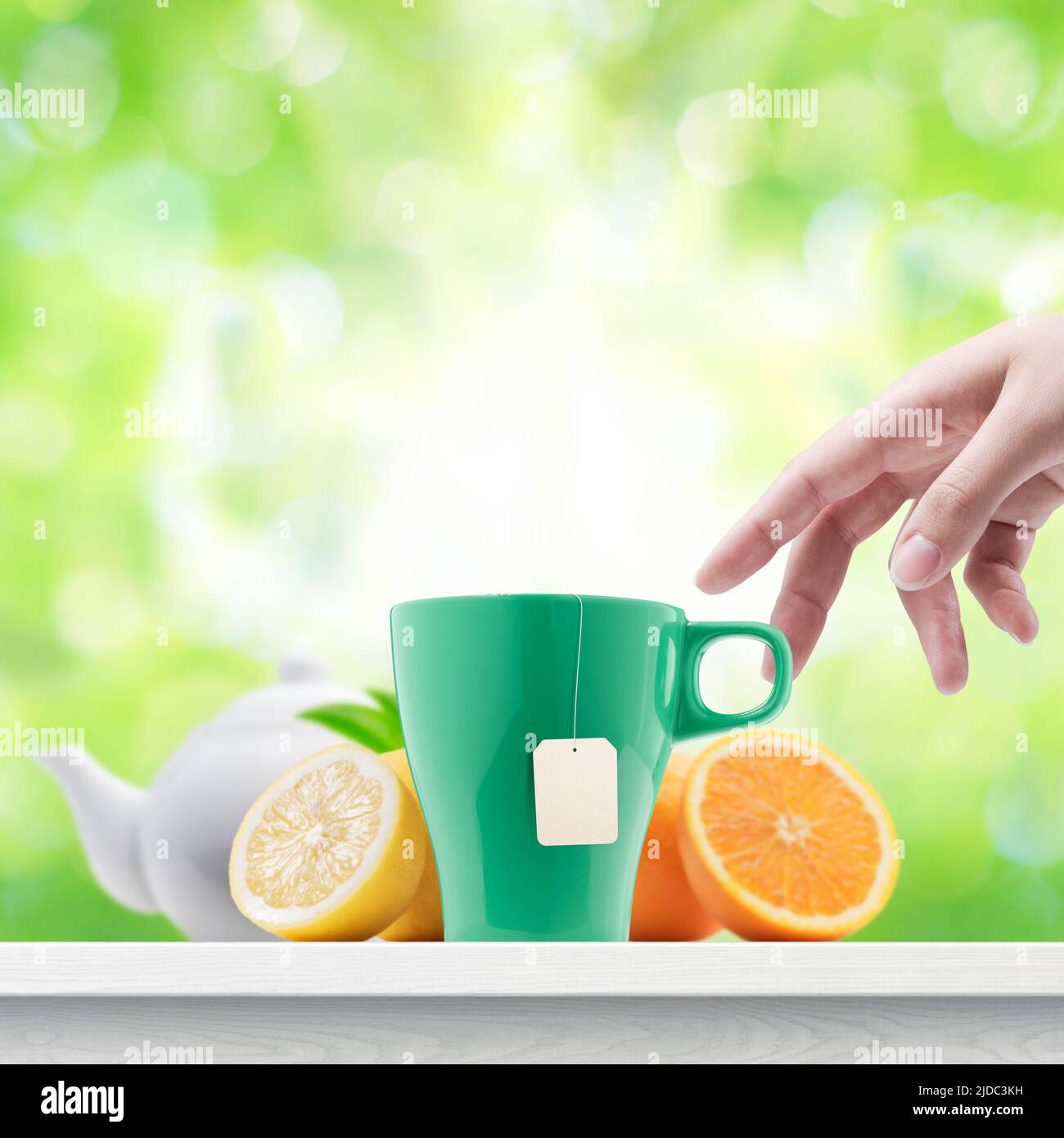 Healthy delicious tea break outdoors in the garden, a woman is taking a ...