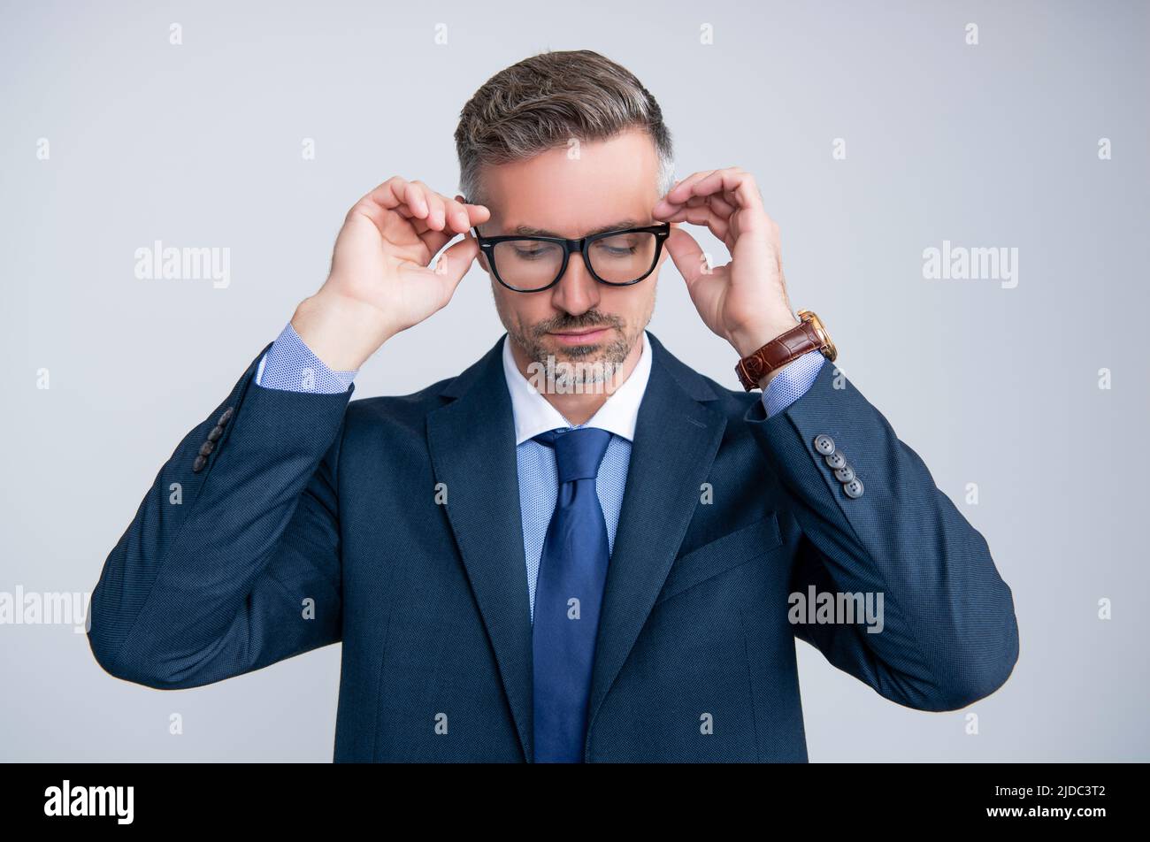 confident mature entrepreneur in businesslike suit on grey background ...