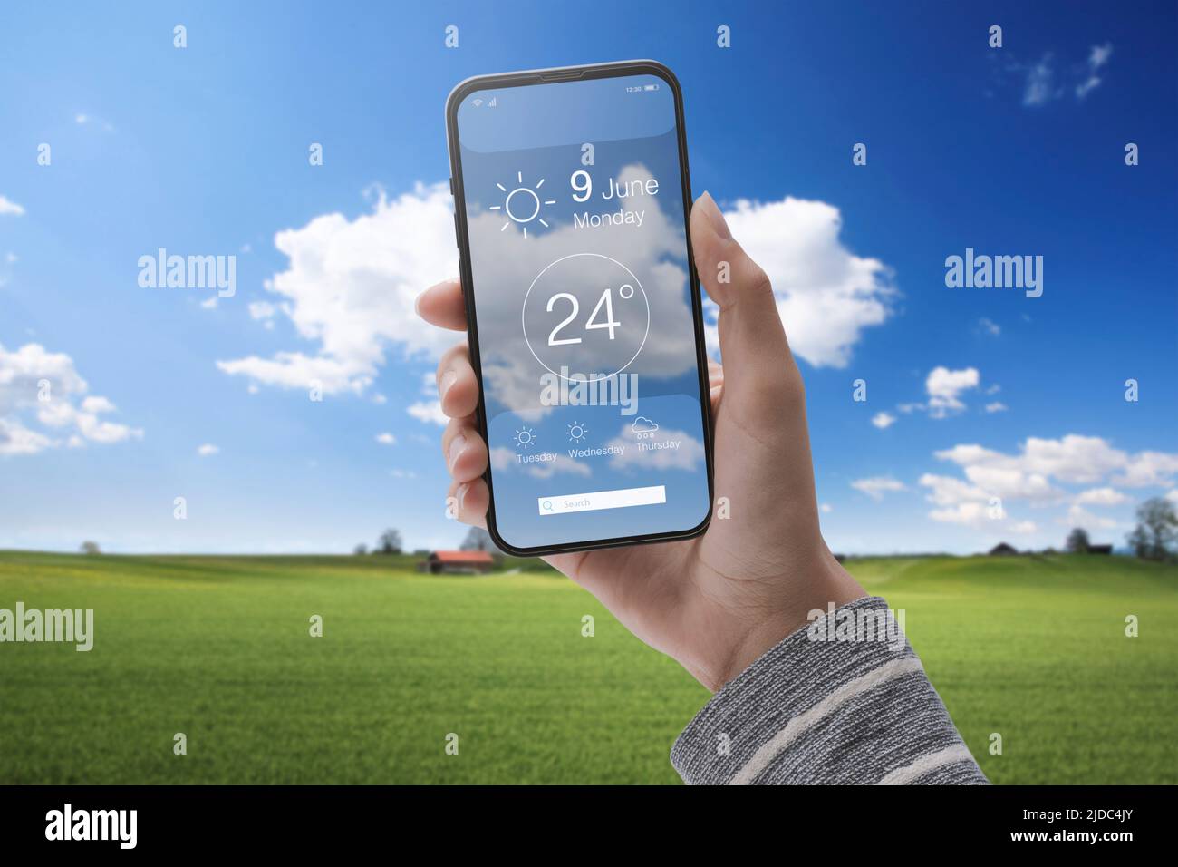 Hand holding a smartphone with weather forecast app on the display ...