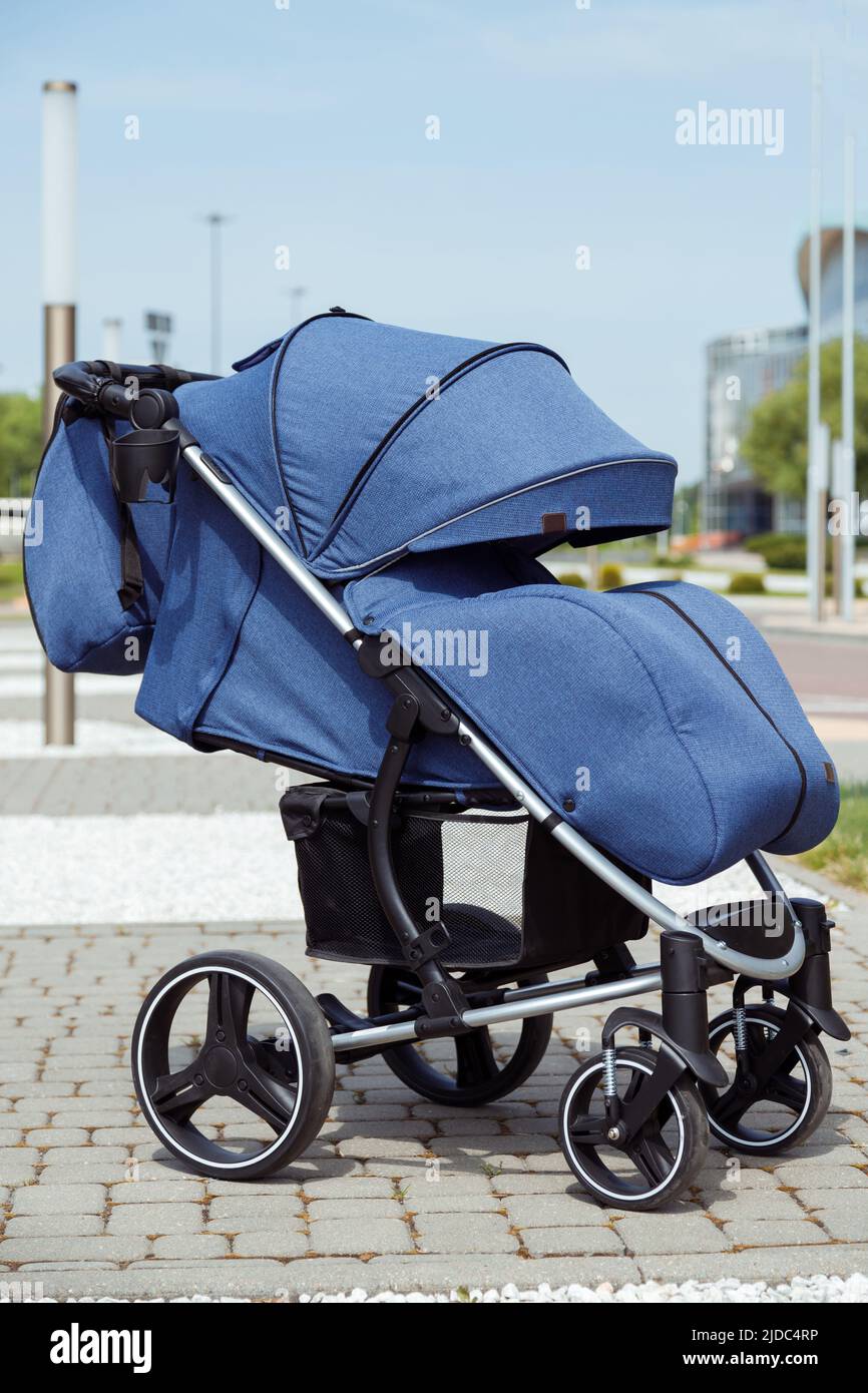 Modern contemporary blue baby stroller with long hood with zipper ...