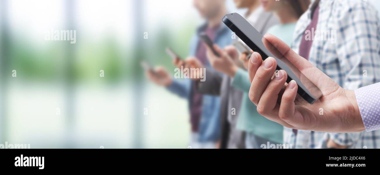 People focused on their smartphones, technology and addiction concept ...