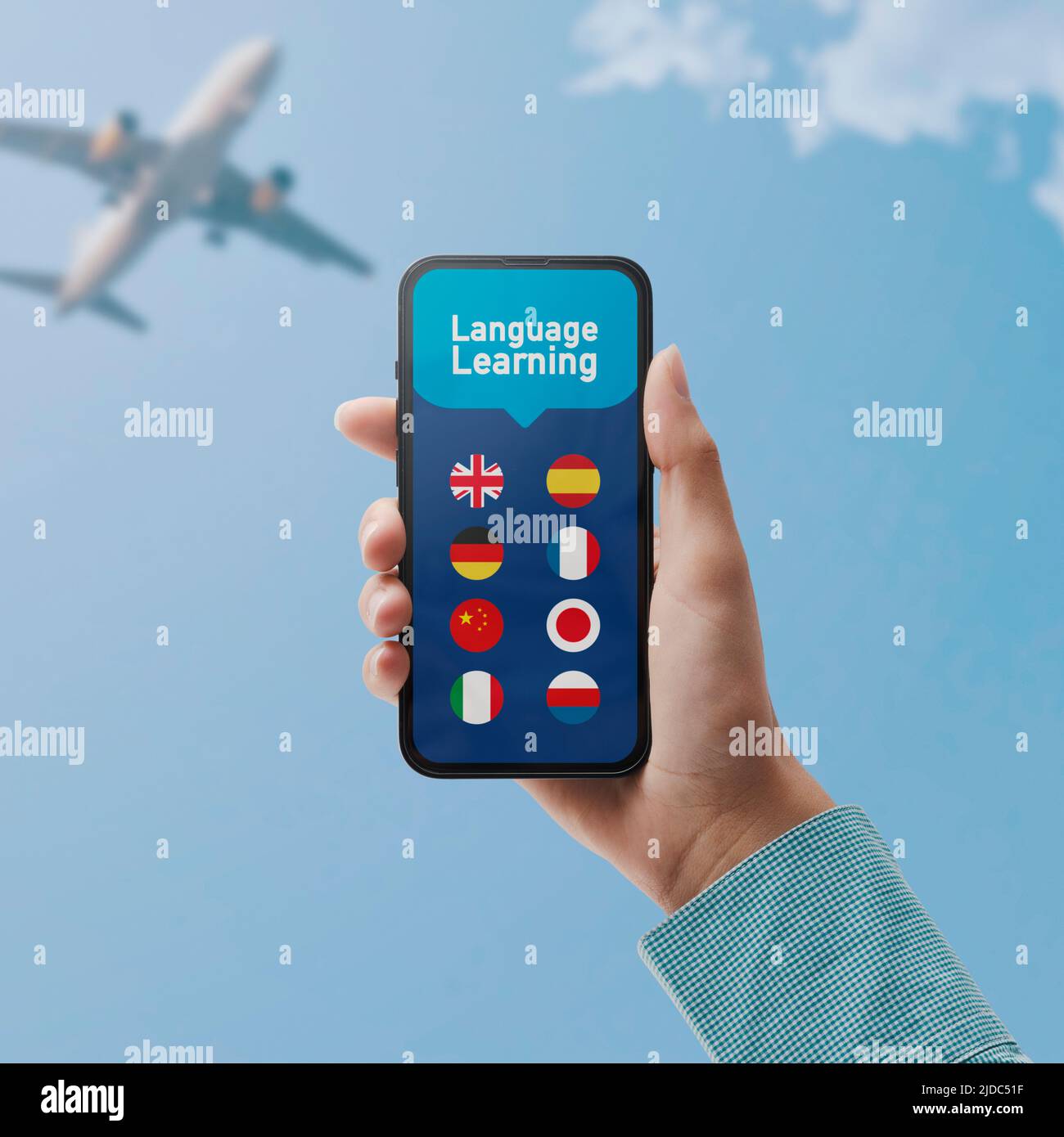 Learn languages online: hand holding a smartphone with language ...