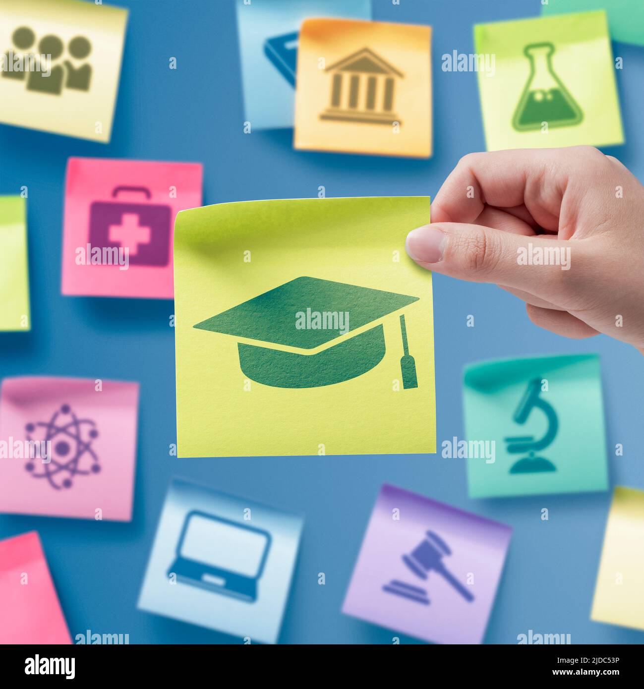 Sticky notes with school subjects icons, a student is holding a note ...