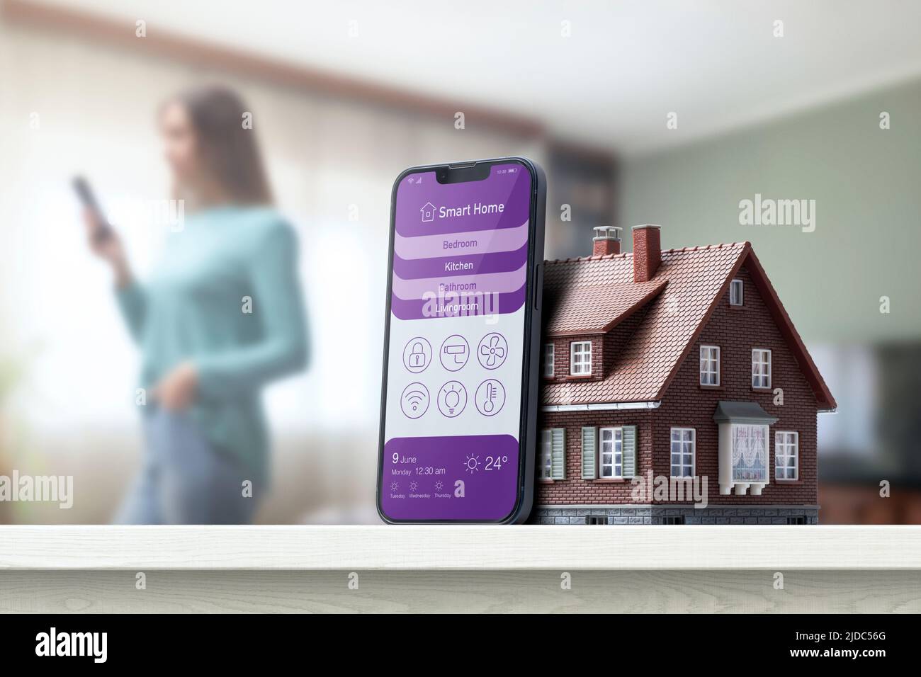 Smart home control app on smartphone and model house, home automation ...