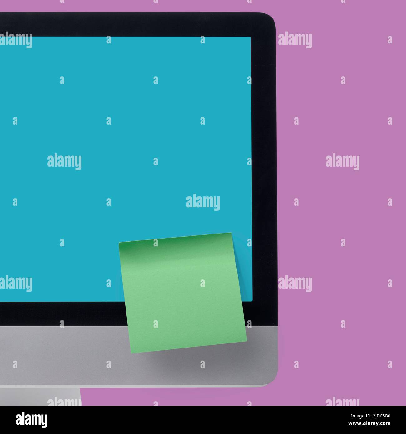 Green sticky note on the computer screen, planning and ideas concept ...