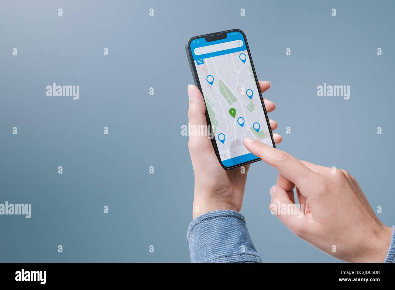 Woman getting directions using a maps application on her smartphone ...