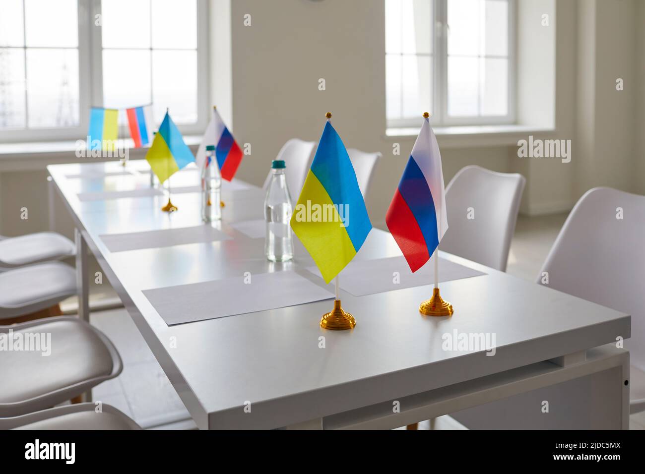 Table with flags of Ukraine and Russia at negotiations aimed at ...