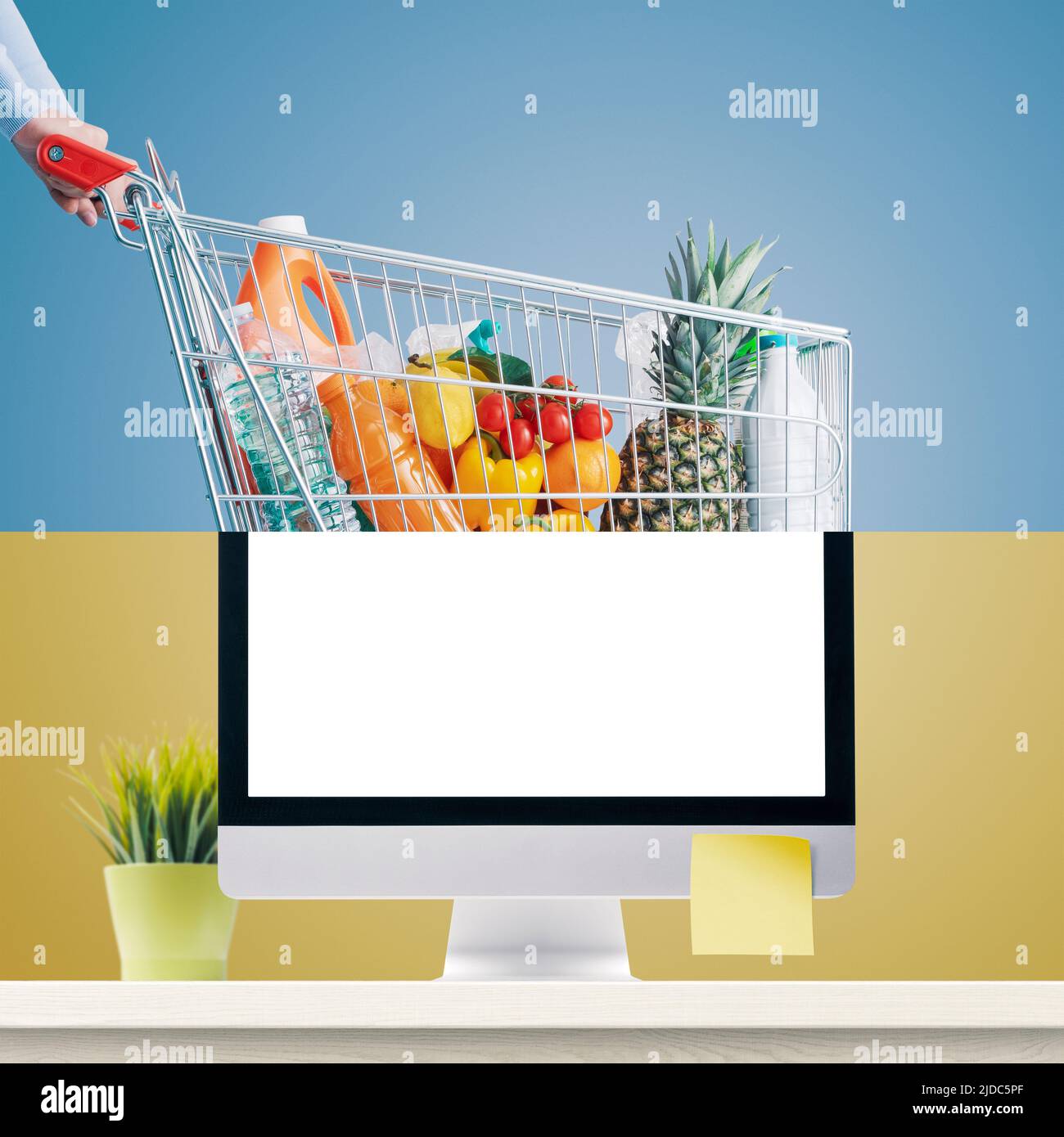 Online grocery shopping: computer and shopping cart full of groceries ...