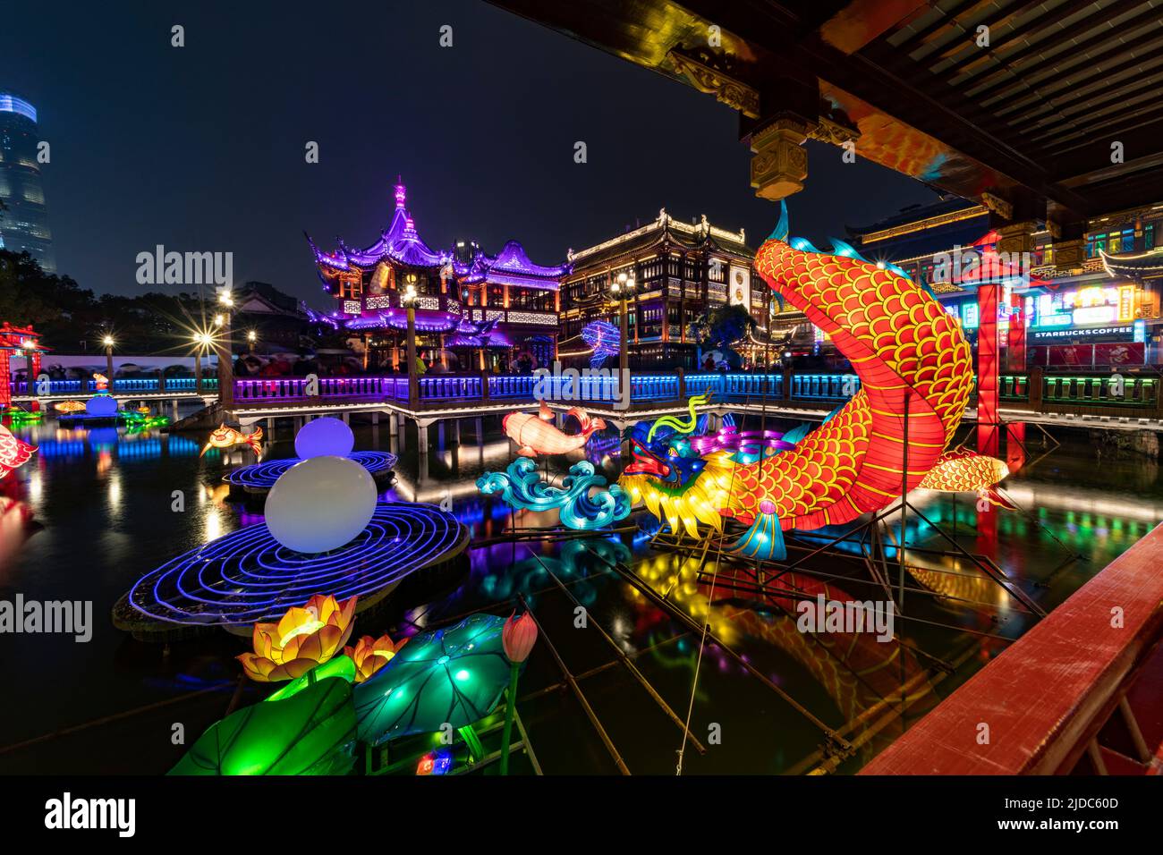 A crowd of tourists walk through the famous Nine-turning-bridge of Yu ...