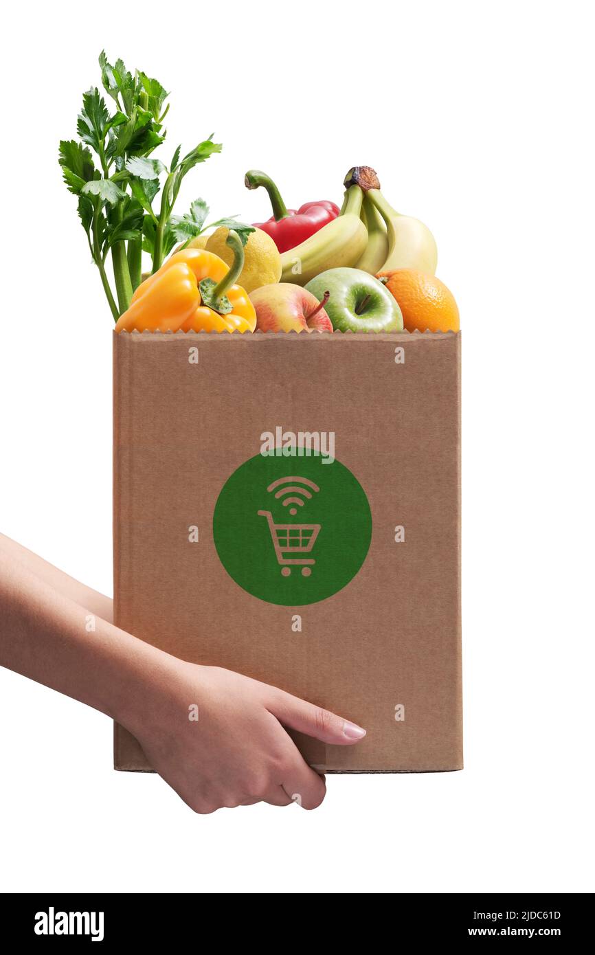 Online grocery shopping and home delivery service: worker carrying a ...