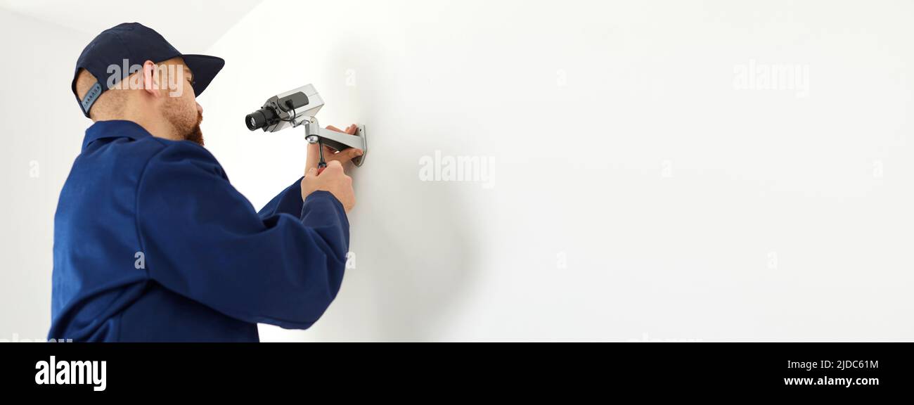 Copy space banner background with man installing CCTV surveillance ...