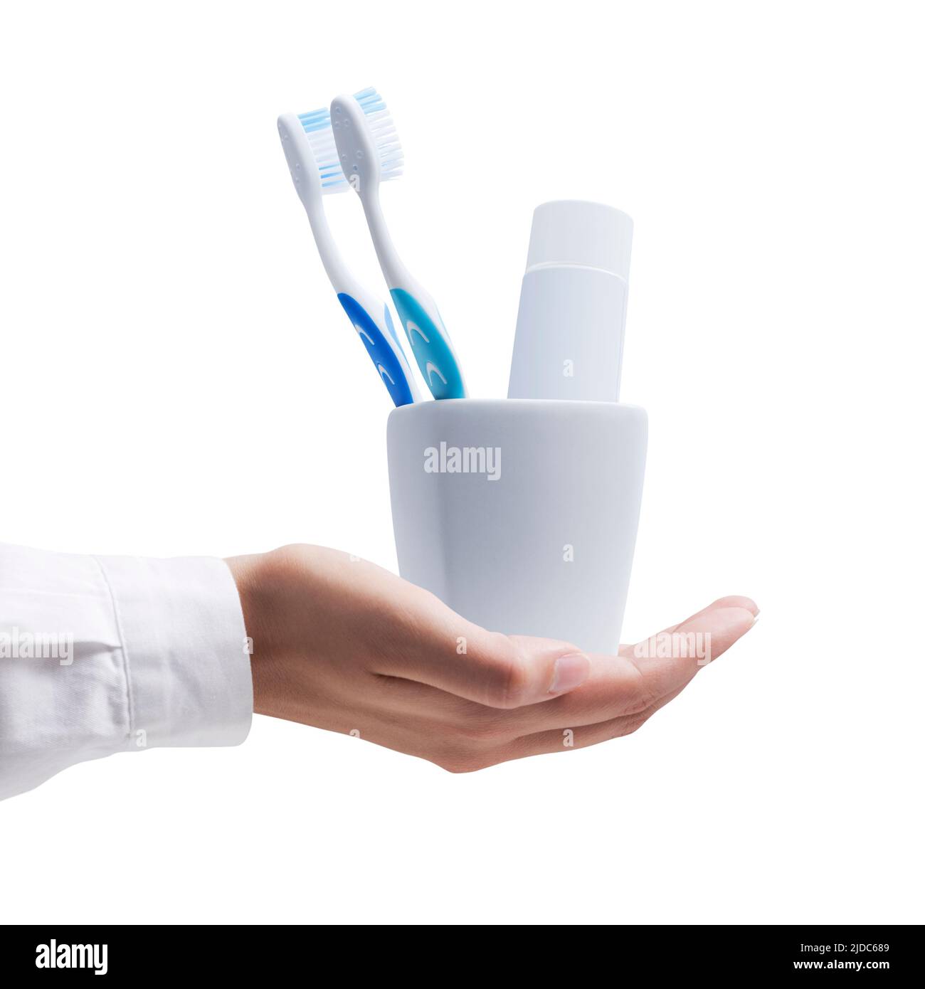 Dentist showing toothbrushes and toothpaste, dental hygiene concept ...