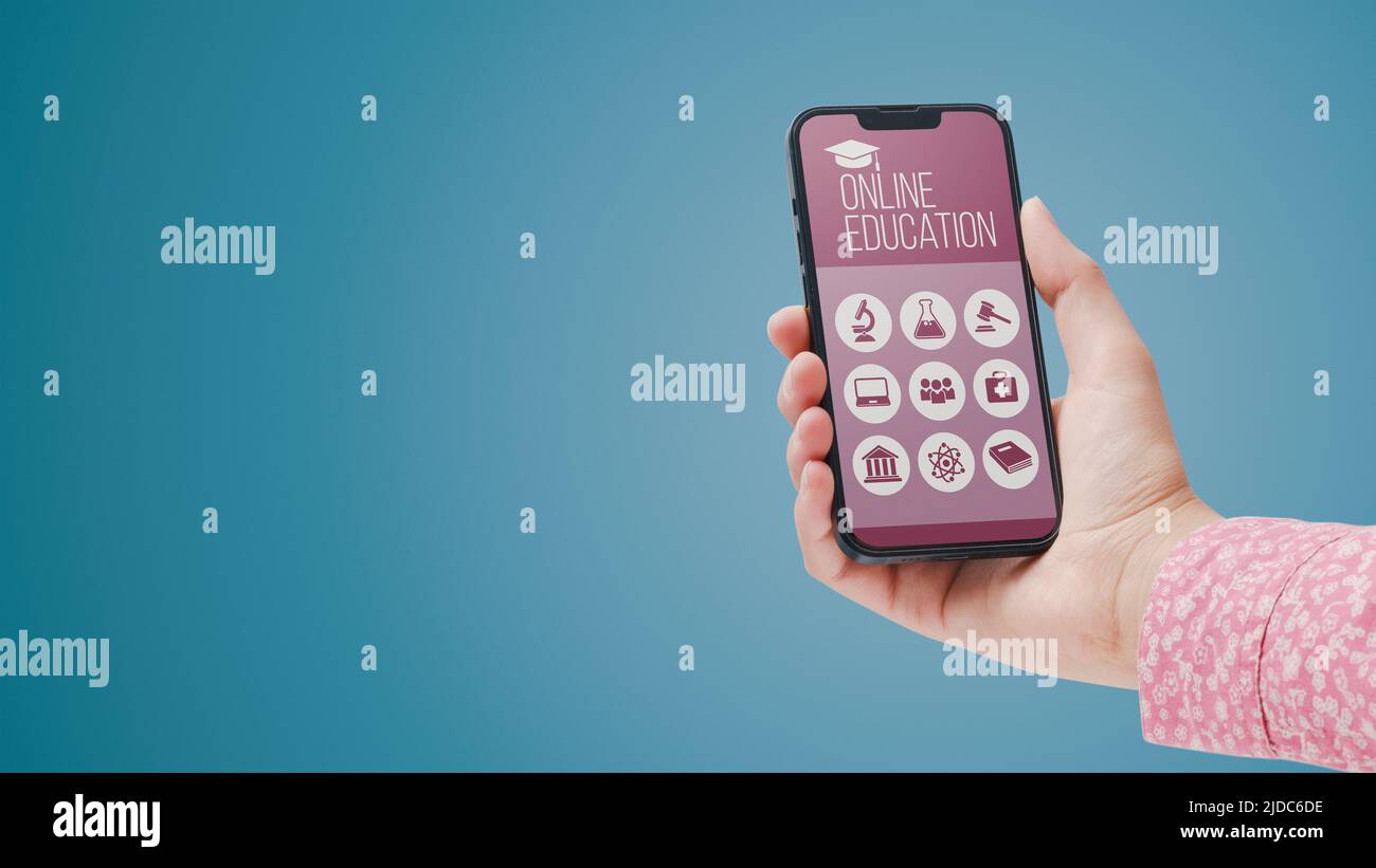 Student holding a smartphone and using online learning apps on ...