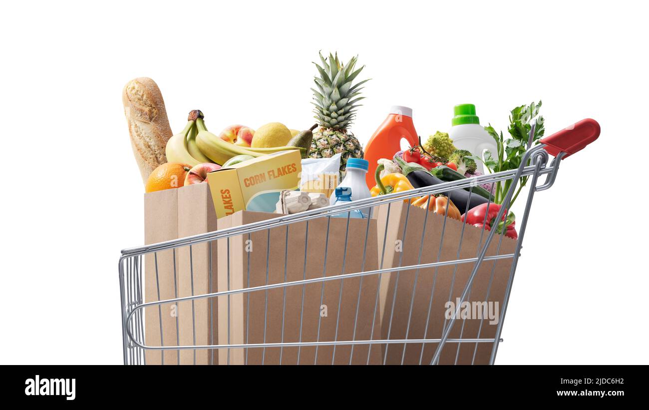 Shopping cart full of fresh groceries, grocery shopping concept ...