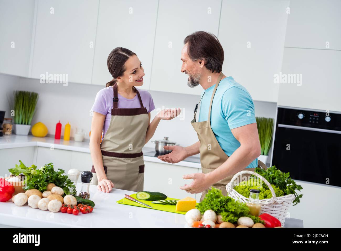 Photo of two positive peaceful partners communicate discuss recipe ...