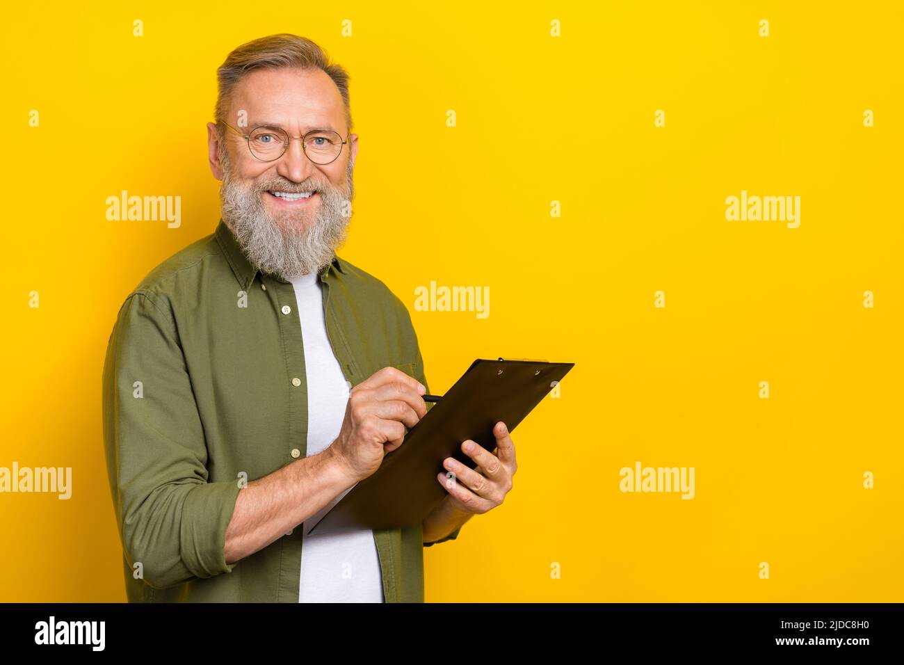 Portrait of cheerful friendly aged person hold clipboard pen empty ...