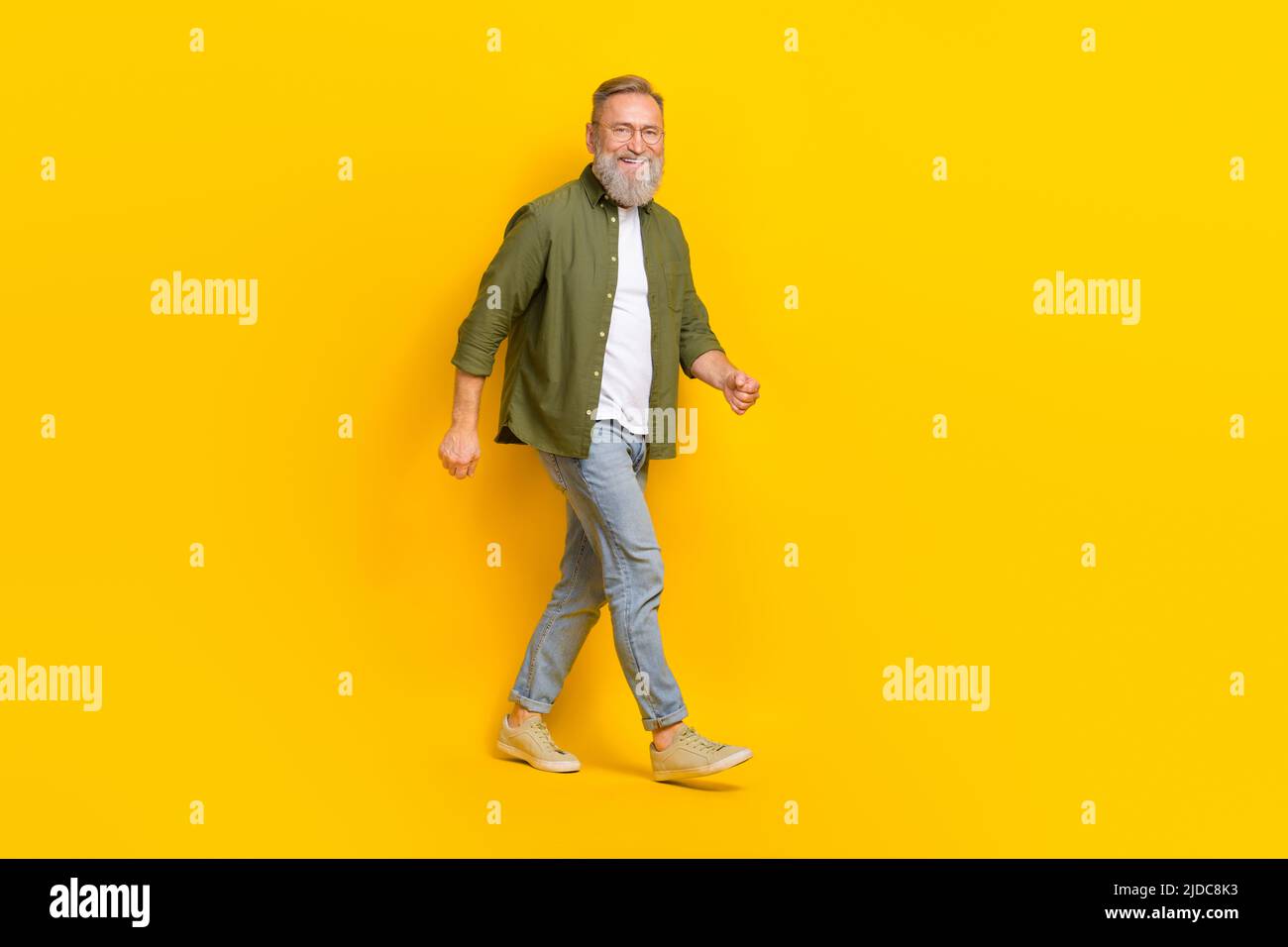 Full length profile portrait of cheerful aged man walking have good ...