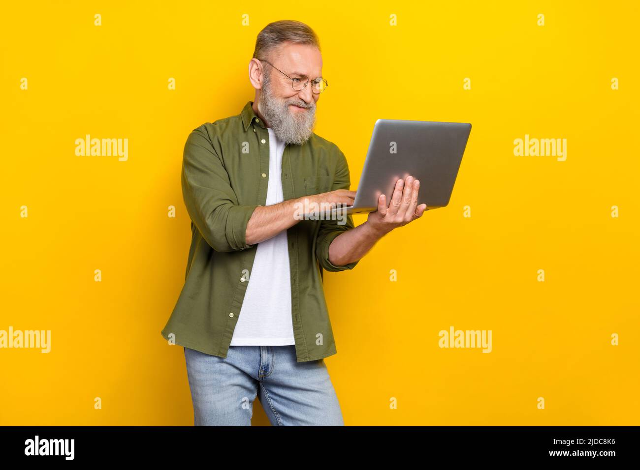 Portrait of aged agent man hold use wireless netbook communicate ...