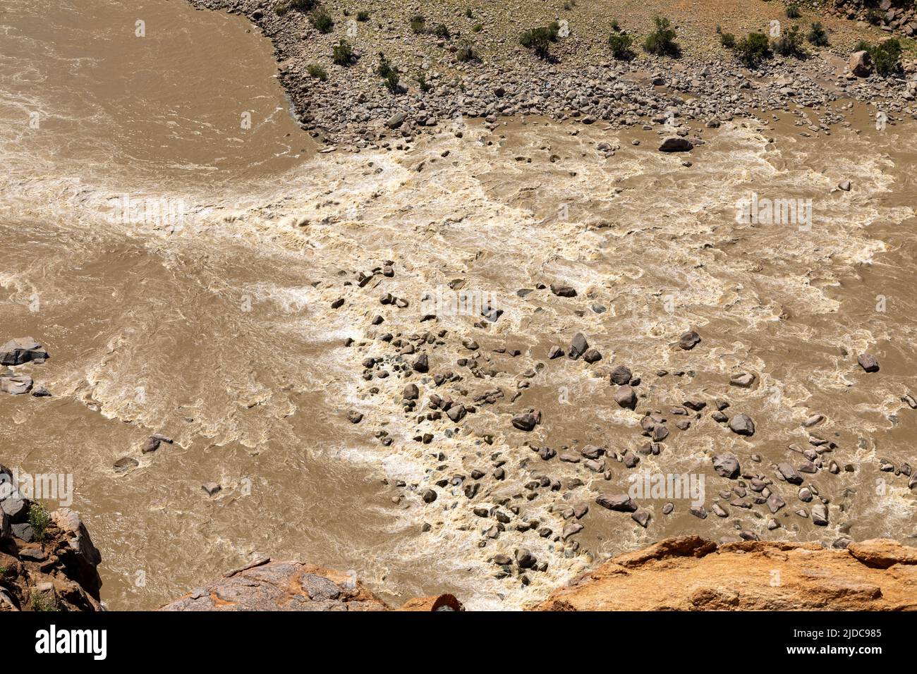Brown and muddy water of the Orange river in the Augrabies National ...