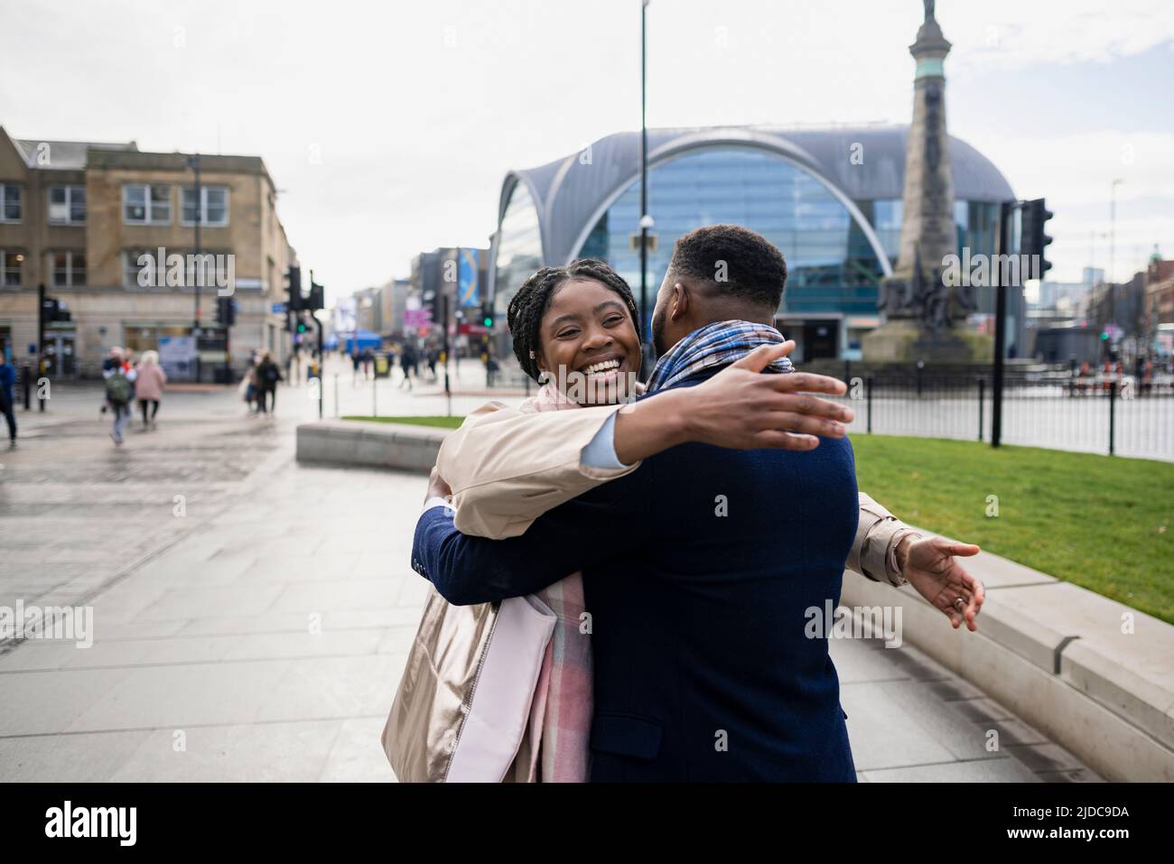 Cheerful woman throwing arms around man, reunion, getting back to the ...