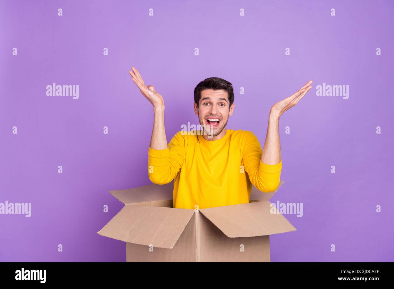 Photo of excited man peek through carton box recommend delivery company ...