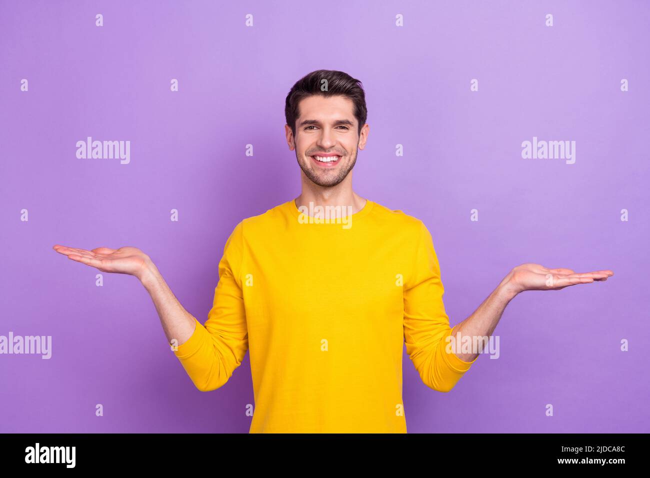 Photo of good mood positive male compare two different product ...