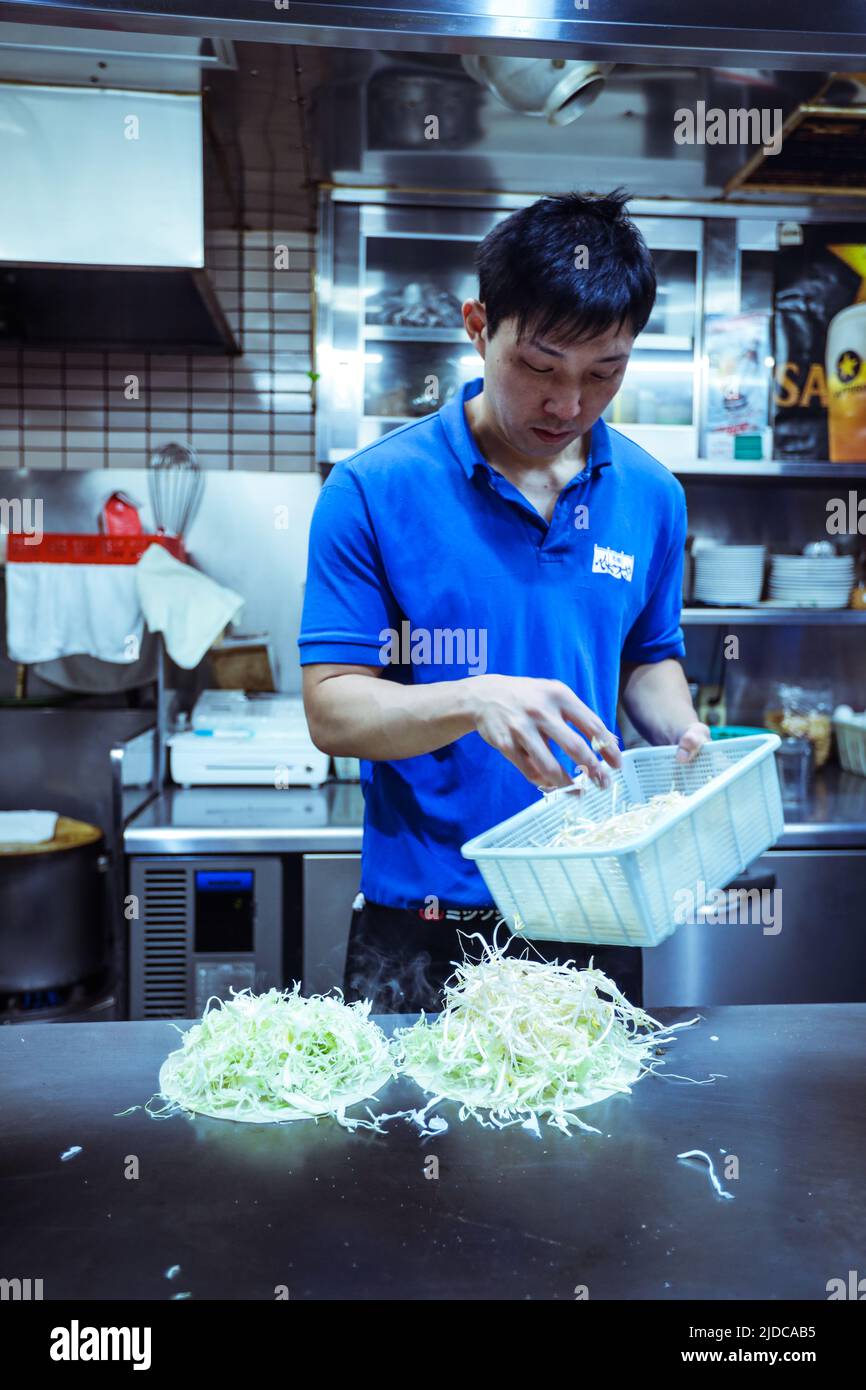Local Cook preparing the Typical Japanese Dish Okonomiyaki in Hiroshima ...