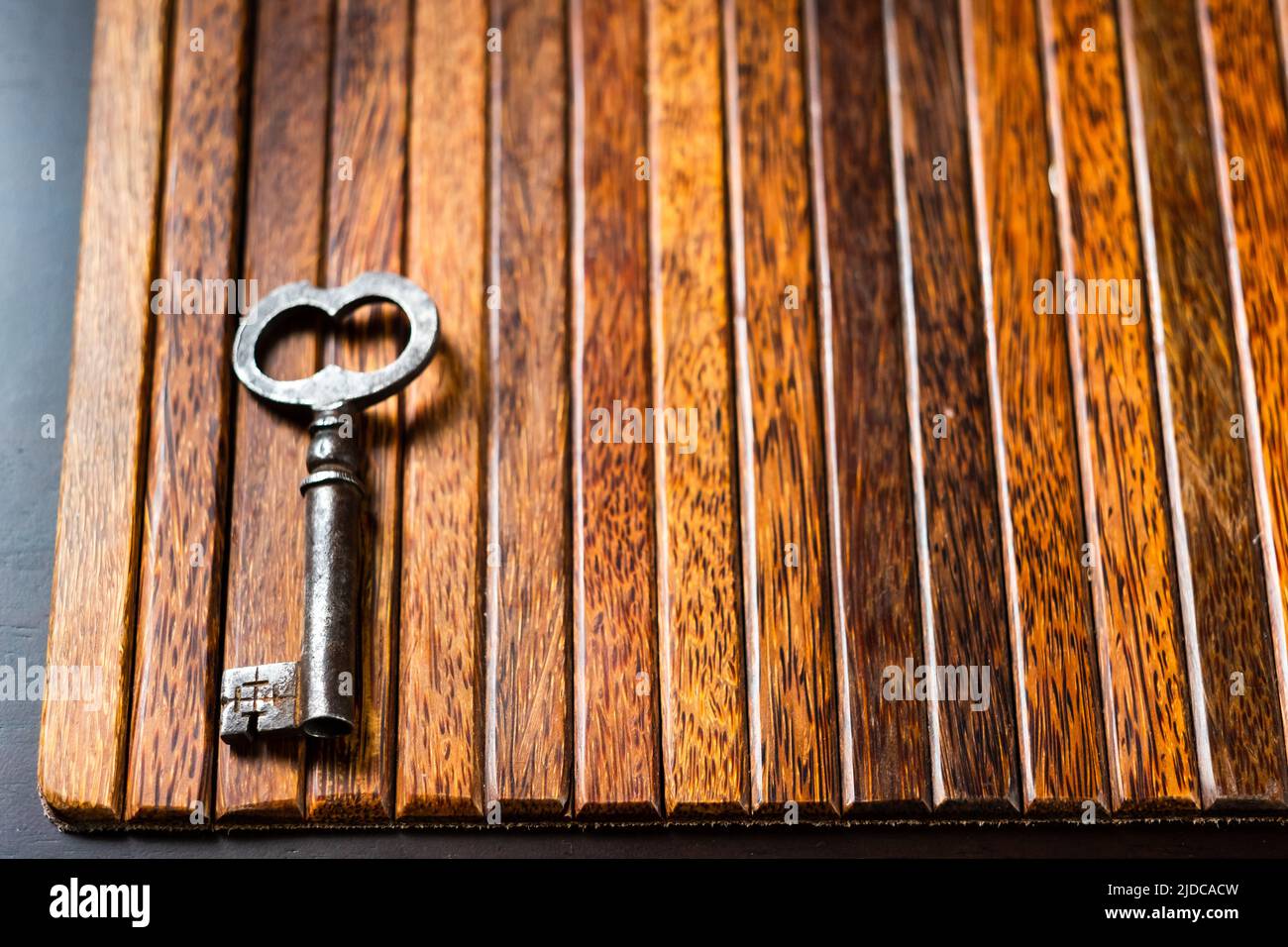 the old key lies on an old wooden table, natural textures, the concept ...