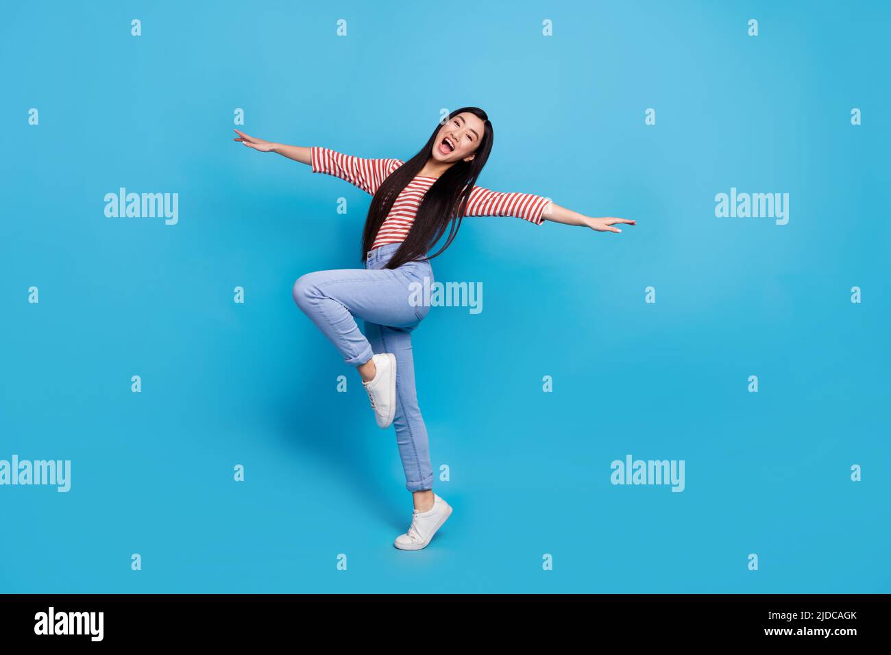 Full length photo of funky excited woman wear striped shirt dancing ...