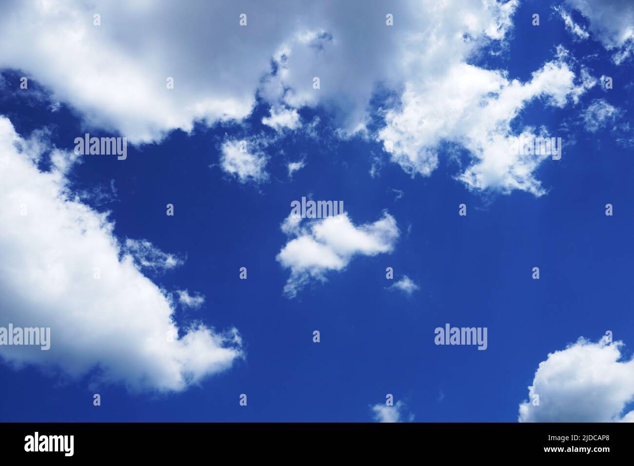 Blue sky with small cumulus clouds Stock Photo - Alamy