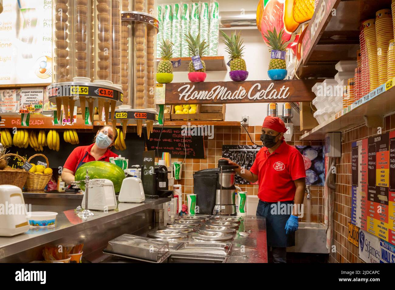 Two shop workers in an ice cream shop at night in Rome Stock Photo - Alamy