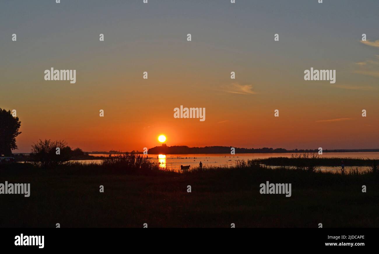 Beautiful sunset. Romantic sunset on the lake. Evening landscape ...
