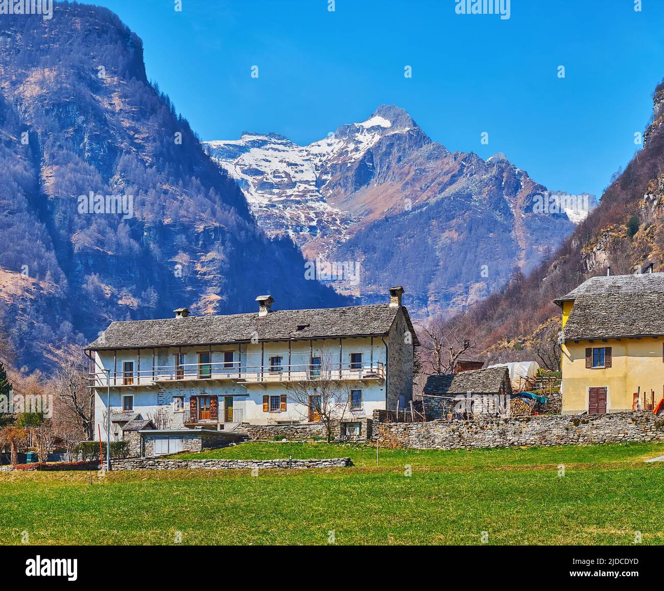 The old houses of Sonogno village in front of snowy rocky Corona di ...