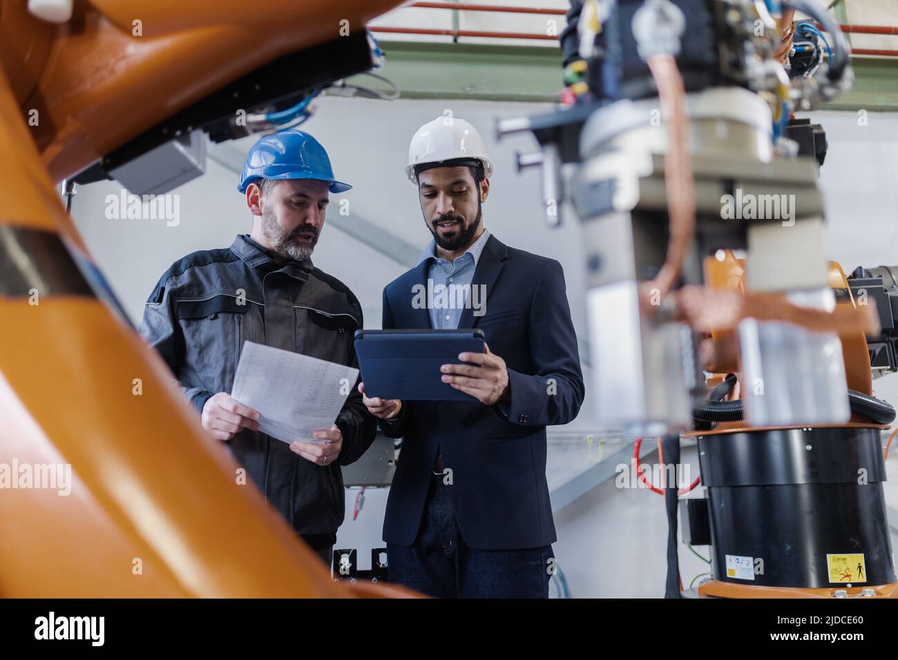Engineering manager and mechanic worker doing routine check up in ...