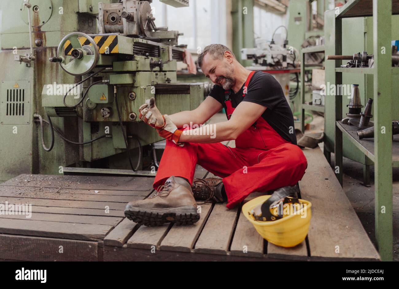 Worker suffering from pain after accident in factory. First aid support ...