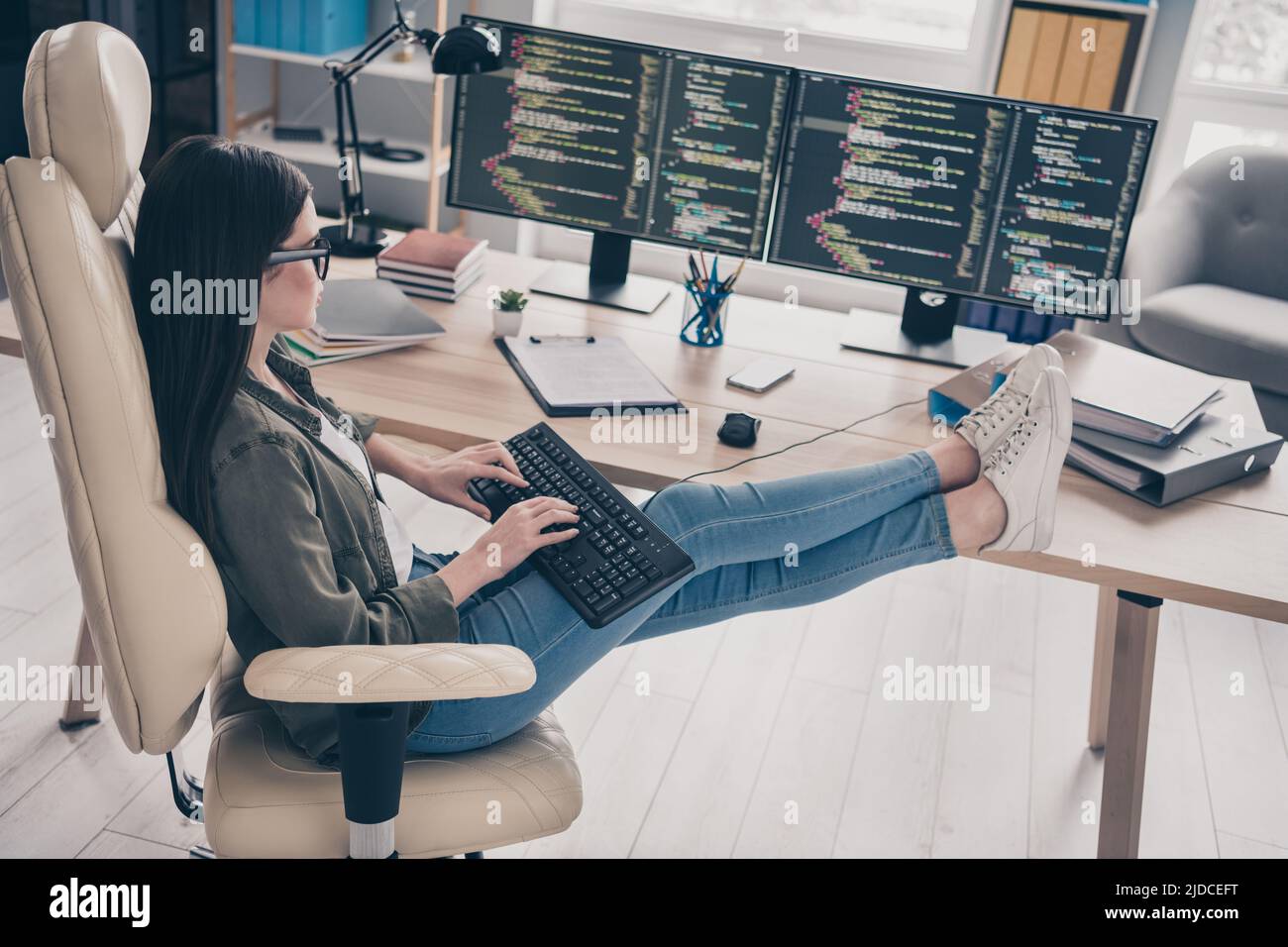 Full body profile side photo of young girl type jawa script designer operating server sit chair ...