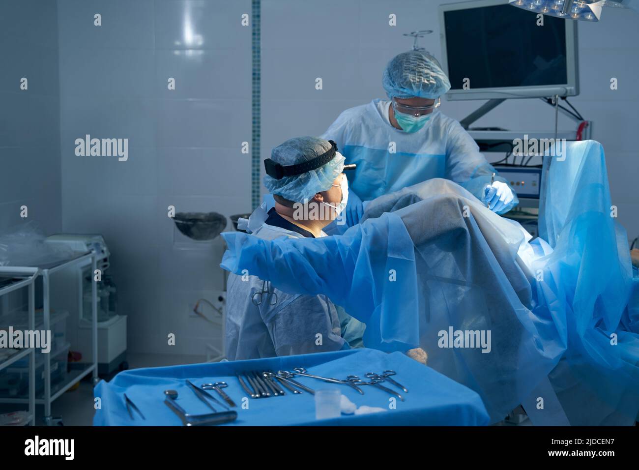 Gynecologist working with his assistant in the operating theatre Stock ...
