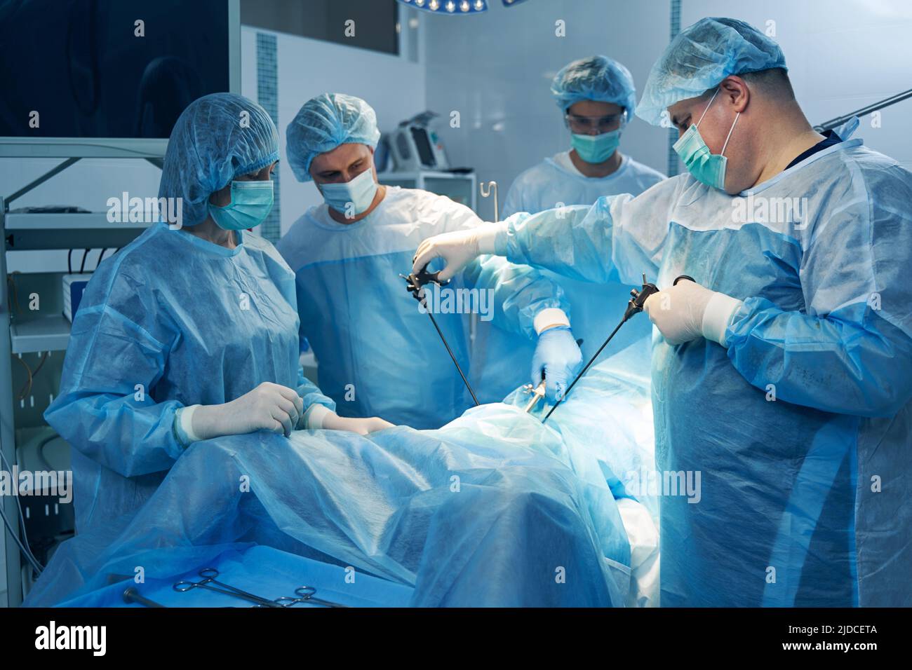 Surgeons and assistants working in the operation theatre Stock Photo ...