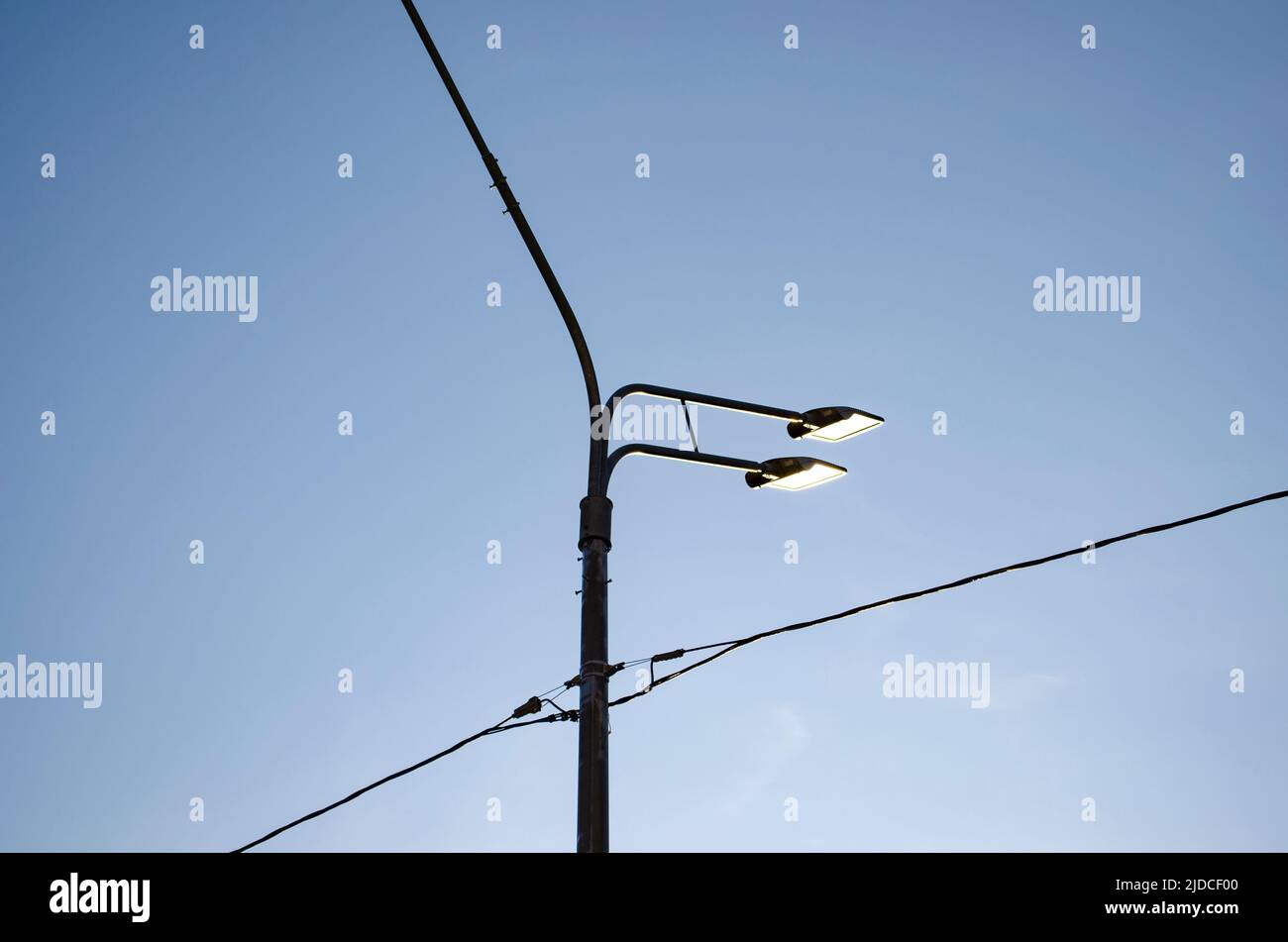 Twilight sky. Two lighting street lights Stock Photo - Alamy