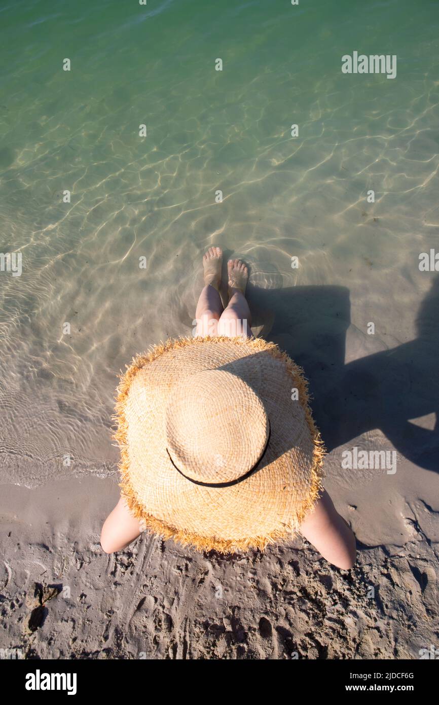 woman in red swimsuit sitting at sandy beach summer sunbathing Stock ...