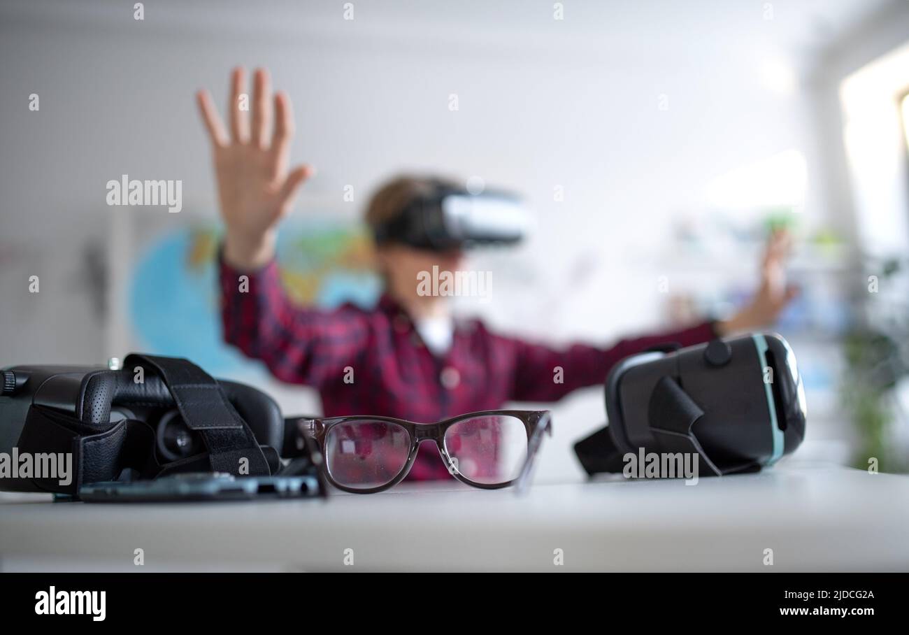 Happy student wearing virtual reality goggles at school in computer ...
