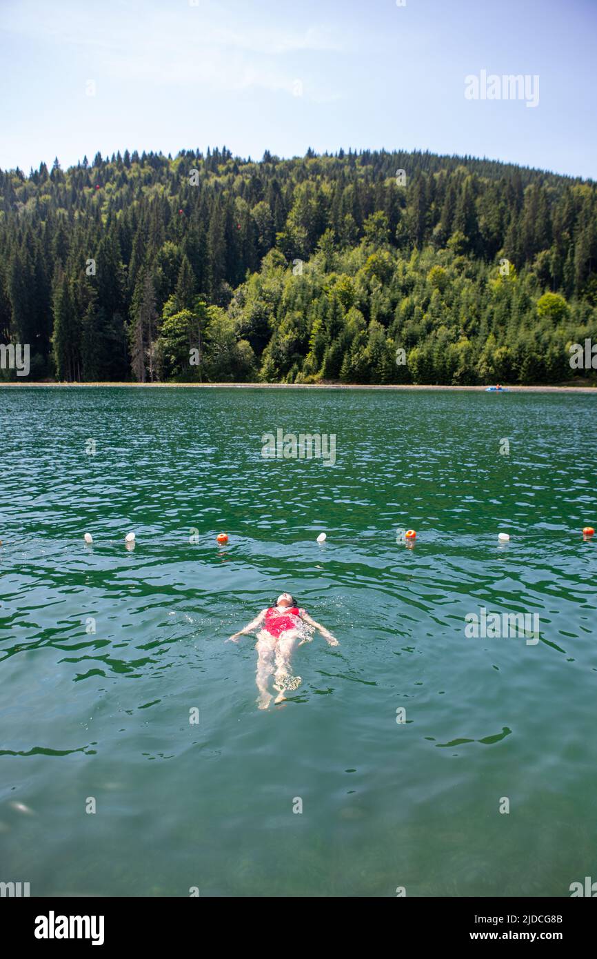 woman floating on back in red swimsuit mountain lake Stock Photo - Alamy
