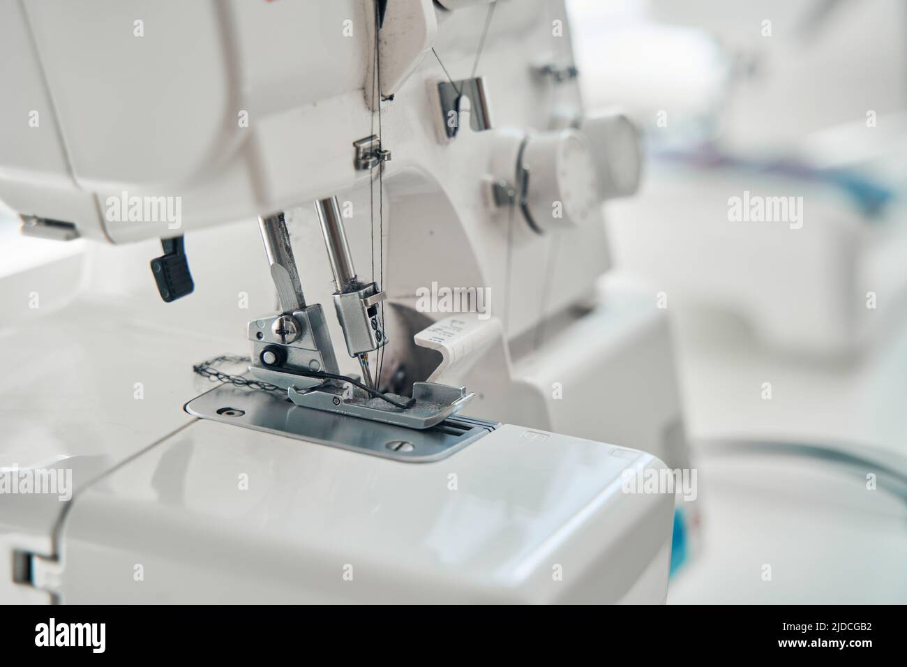 Sewing machine during working process in atelier Stock Photo - Alamy