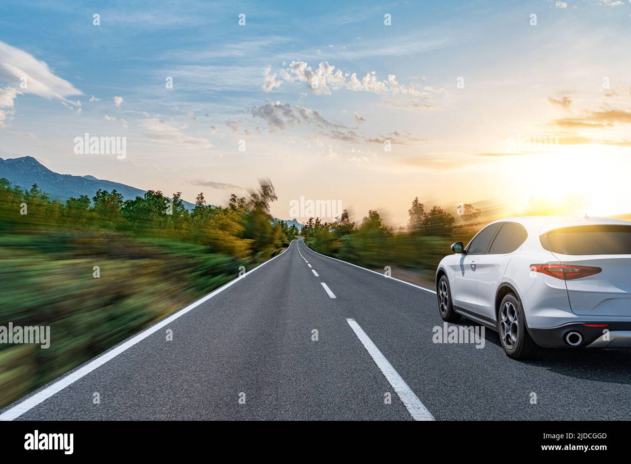 A white car drives along a beautiful road Stock Photo - Alamy